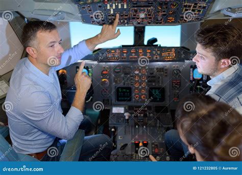 Man Showing Cockpit Controls To Young People Stock Image Image Of
