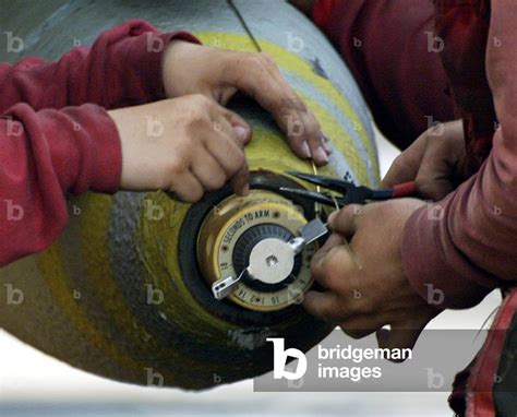 Image Of Flight Deck Ordnance Handlers Attach Wires And Make Final