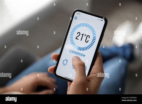 Man Using Smartphone To Control Heating System In House Closeup Stock Photo Alamy