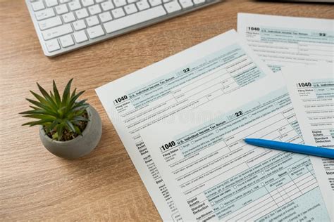 1040 Tax Form Documents With Pen And Computer Keyboard On Office Desk