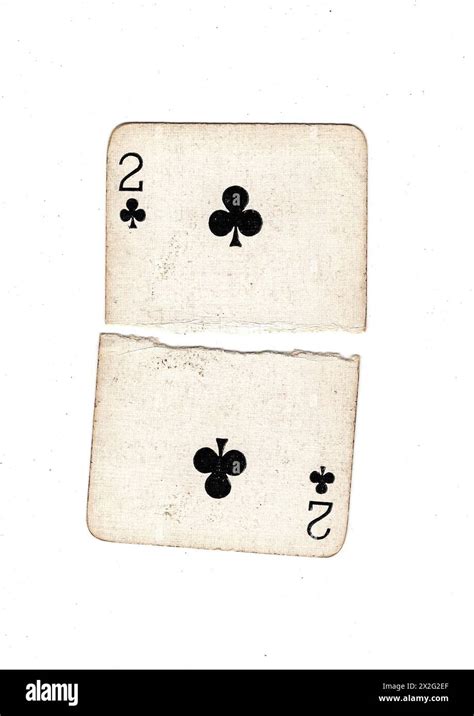 A Vintage Well Used Two Of Clubs Playing Card Torn In Half On A White