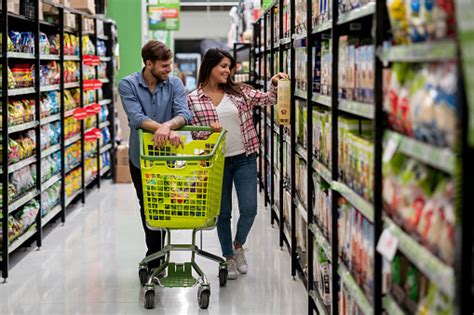 슈퍼마켓에서 식료품을 쇼핑하는 행복한 커플과 선반에서 시리얼을 들고 미소 짓는 여성 생활 방식에 대한 스톡 사진 및 기타 이미지 생활 방식 슈퍼마켓 커플 Istock