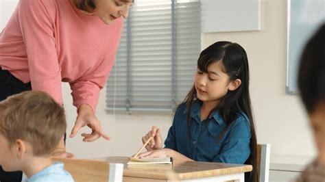 Premium Photo Asian Girl Writing Or Taking A Note While Teacher