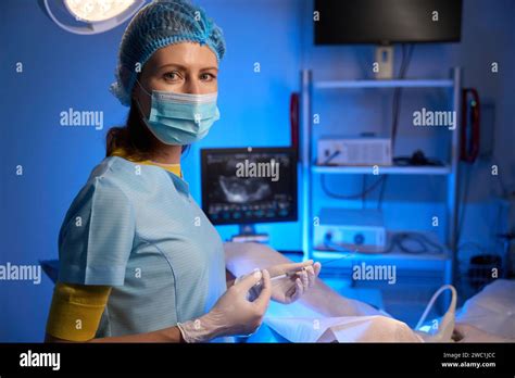 Female Doctor Using Syringe For Artificial Fertilization In