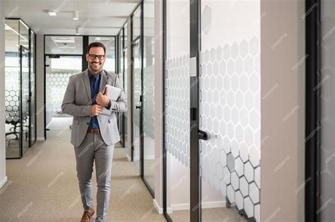 Premium Photo Portrait Of Smiling Handsome Ceo In Glasses Holding
