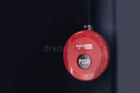 Manual Emergency Notification Tool For Fire Alarm System Red Mounted On A Black Gray