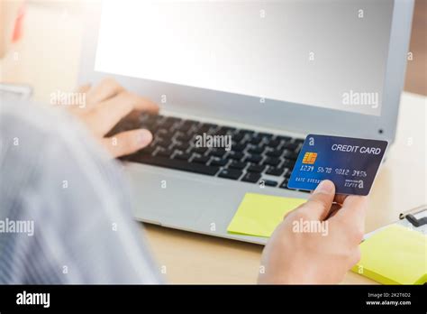 Business Man Hand Holding Credit Card And Typing Entering Security Code