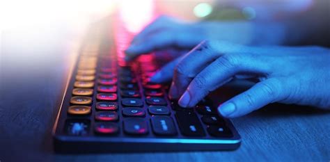 Premium Photo Hacker Hands And Typing On Neon Keyboard For Software Programming Or