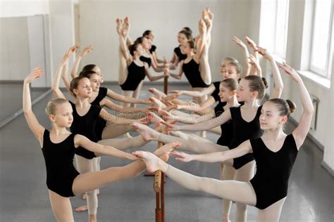 Group Of Ballerinas Training At Ballet Barre Young Ballet Girls In Leotards Practicing At