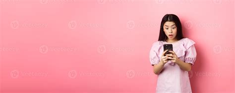 Online Shopping Asian Teen Girl Look Surprised At Mobile Phone Screen