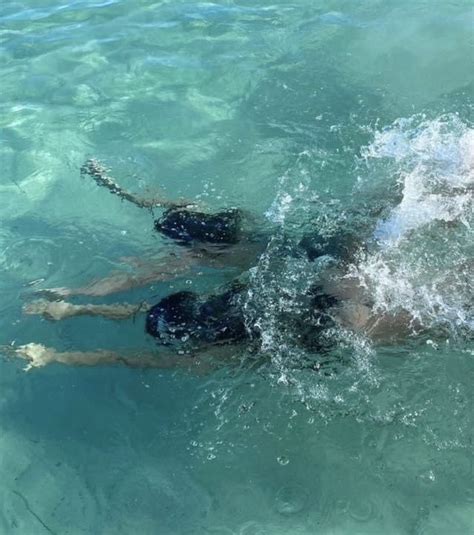 Two People Are Swimming In The Water