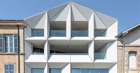 recessed angular frames form art house cinema s facade in france