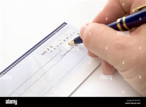 Person Writing A Cheque Using A Blue Pen Stock Photo Alamy