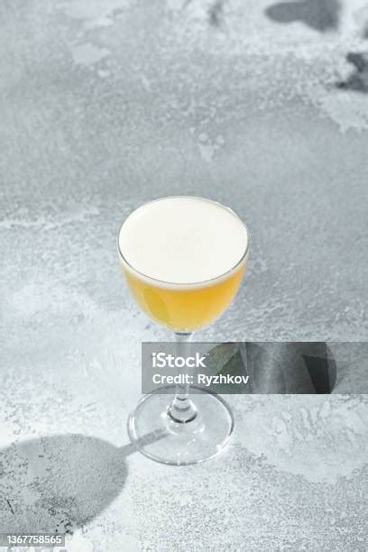 위스키 사워 칵테일은 달걀 흰자를 곁들인 위스키 기반 칵테일입니다 햇빛과 그림자 빈티지 테이블 위스키 설탕 시럽 레몬 주스를 곁들인 강한 알코올 음료 새콤한 맛에 대한 스톡