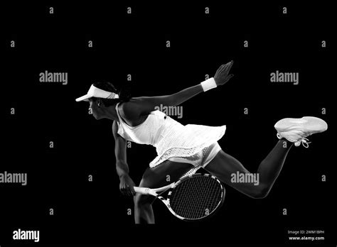 Action Shot Of Female Tennis Player Performing Backhand Stroke Against