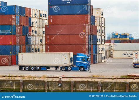 Container Terminal In Rotterdam With Truck In Front Of Stack Of