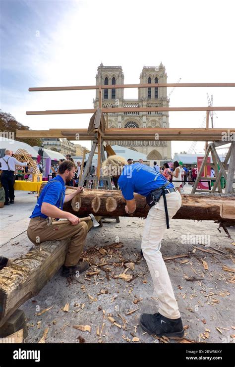 Two French Artisan Carpenters And Woodworkers Demonstrate Using Traditional Axes To Prepare Oak