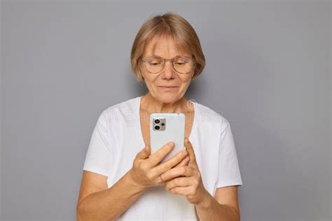 Senior Woman Wearing Glasses Browsing Online Shopping Website On