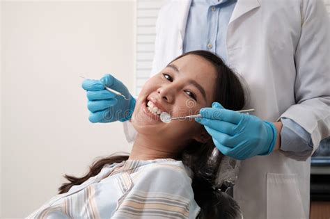 Asian Female Face White Teeth And Cheerful Face In The Dentist Clinic