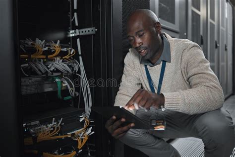 Data Center Or Black Man On Tablet In Server Room On Database Maintenance Or Software Update