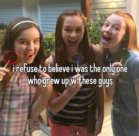 Three Girls Are Laughing And Holding Up Their Cell Phones With The