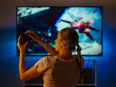 Uma Jovem Loira Senta Se Em Frente A Uma Tela De Televis O E Joga Um Videogame Ela Est