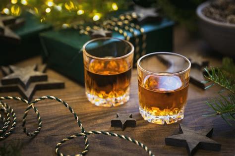 Premium Photo Two Shot Glasses Of Whiskey Or Bourbon With Holiday Decoration