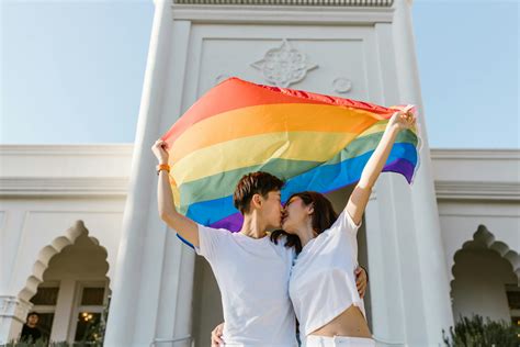 Two Lesbian Girls Kissing Each Other And Carrying Rainbow Flag · Free
