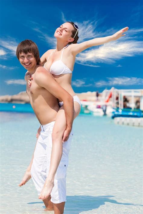 Young Couple Is Having Fun On The Beach Stock Image Image Of Bonding