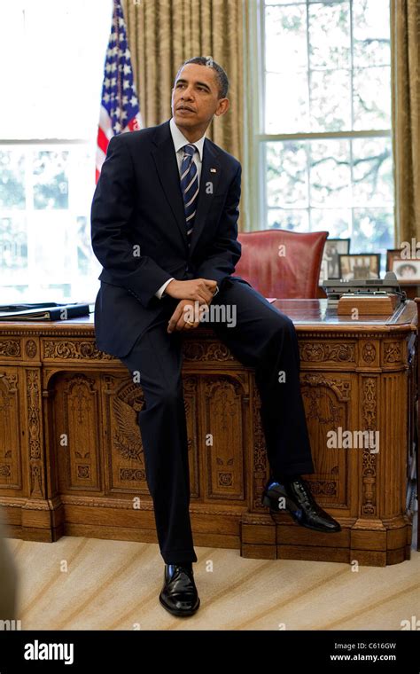 President Barack Obama Sits On The Edge Of The Resolute Desk In The Oval Office April 30 2010
