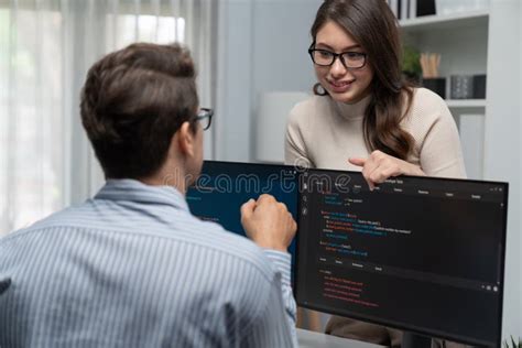 Woman Standing Opposite To Man Programmer Working On Desk To Discuss Postulate Stock Image