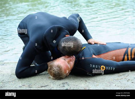 Lesson Of Artificial Respiration Lifeguard Listening To The Drowning Mans Breathing Before