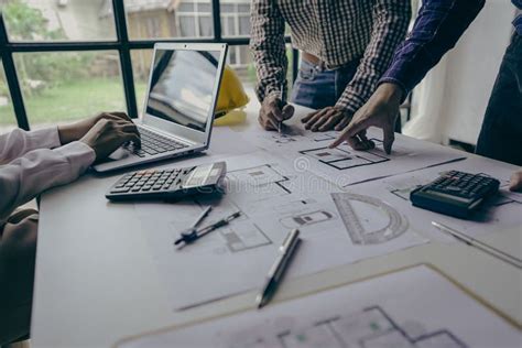 Engineering Team Meeting For Colleagues Discussing And Reviewing Blueprints Stock Image Image