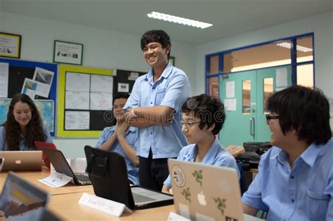 A Group Of Students In A Classroom Working Together On An Exercise A Group Of Students In A Classroom Working Together On An Exercise