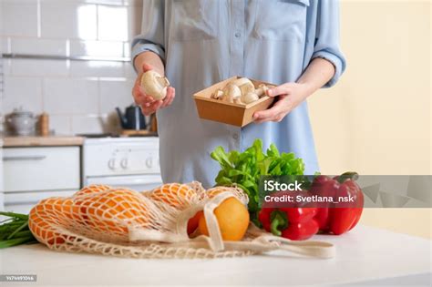 집에서 인터넷에서 주문한 식료품과 함께 쇼핑백에서 식료품을 꺼내는 여자 신선한 유기농 야채 채소 및 과일 주방 인테리어 음식 배달 개념 가방에 대한 스톡 사진 및 기타