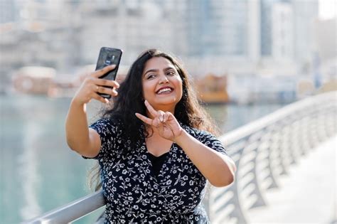 Premium Photo An Indian Girl Takes A Selfie On Her Phone While