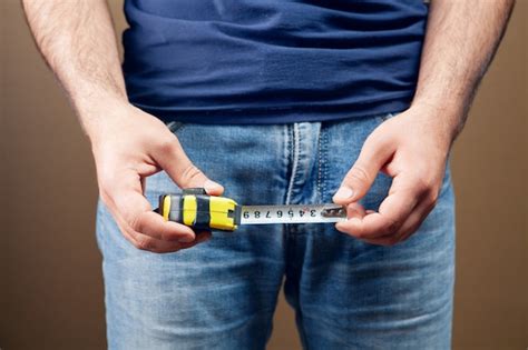 Premium Photo A Man Holds A Measuring Tape In His Hands