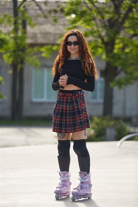 Cute Young Adult Skater Standing In A Skatepark In Modern Aggressive