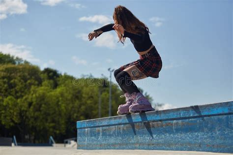Young Roller Blader Grinding On A Ledge In A Skatepark Cool Female Skater Wearing Modern