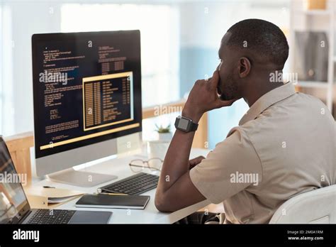 Pensive Software Engineer Checking Programming Code On Computer Screen