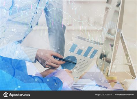 Double Exposure Of Chart With Businessman Typing On Computer In Office On Background Concept Of