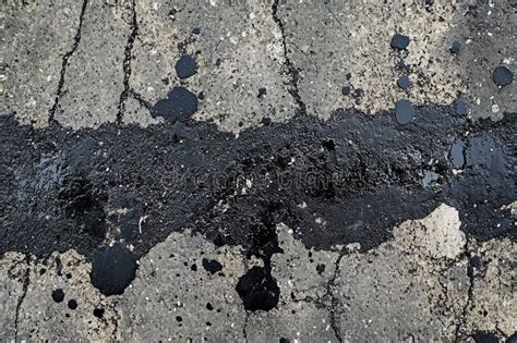 weathered asphalt with cracks and dark patches neural network ai