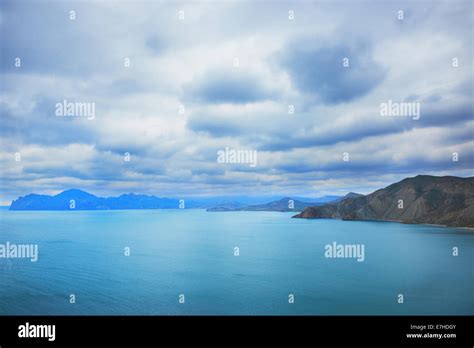 Sea Harbor With Blue Water пкуут ашудвы And Blue Sky With Clouds Stock