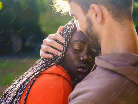 Premium Photo Multiethnic Lovers Hugging In The Park Caucasian Man