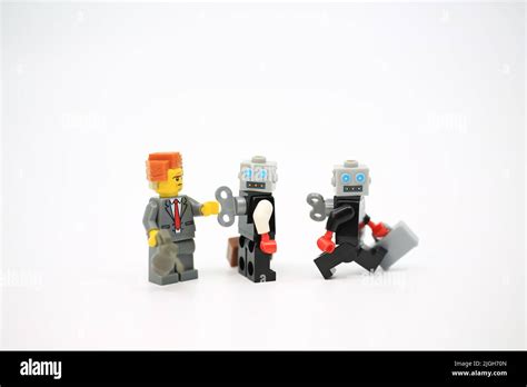 Man Help To Wind Up The Clockwork Robot Stock Photo Alamy