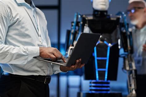 Premium Photo Engineer Using Laptop To Program Robot