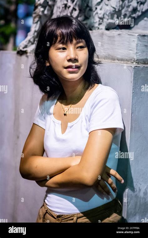 A Pretty Young Filipino Girl Stands Outside Santo Nino De Tondo Church