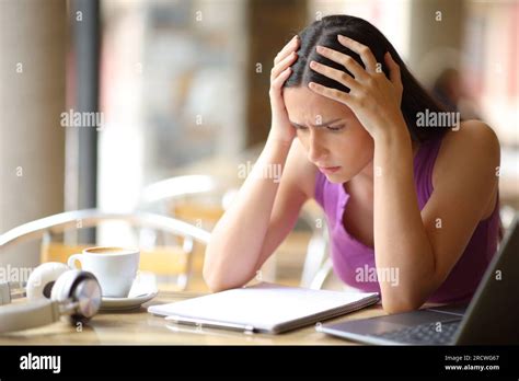 Worried Student Trying To Memorize A Lesson From Notebook In A Bar Terrace Stock Photo Alamy