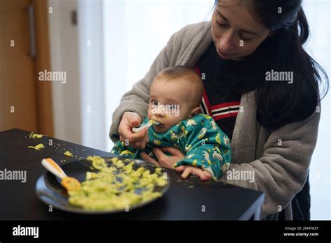 Mother Feeding Her Baby Boy Stock Photo Alamy