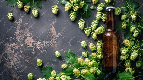 premium photo a cluster of hops next to a bottle of craft beer